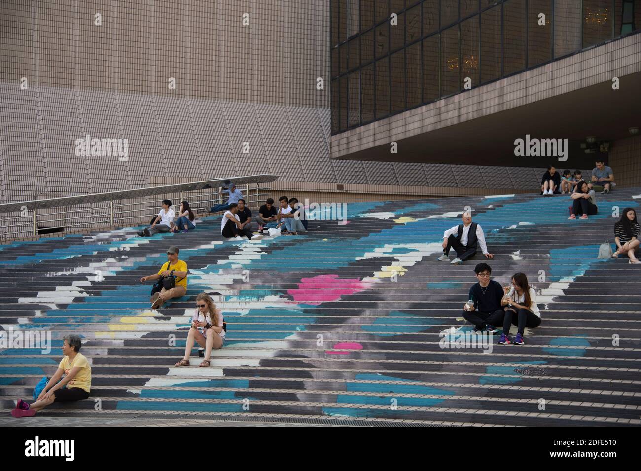 Students lounge on the steps of the city library, Hong Kong, China ...