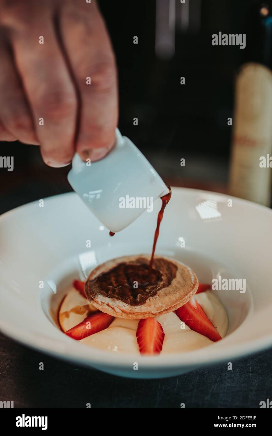 A vertical shot of pancake with fresh strawberries and syrup Stock ...