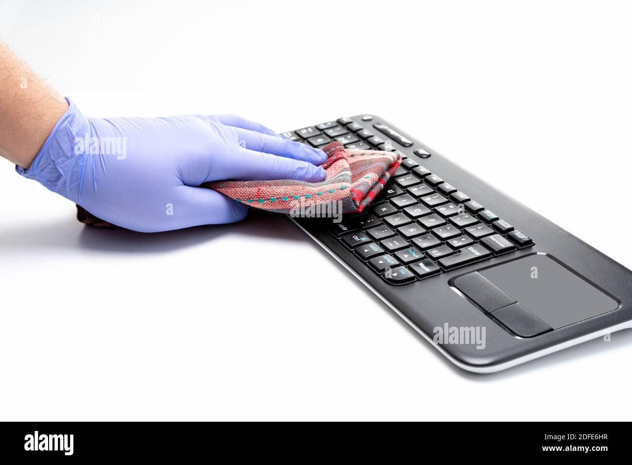 Gloved hands cleaning computer keyboard on white background Stock Photo ...