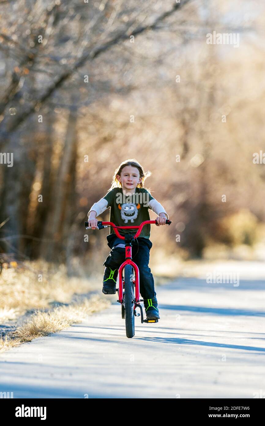 Happy young boy riding his bike on a paved trail; Salida; Colorado; USA ...