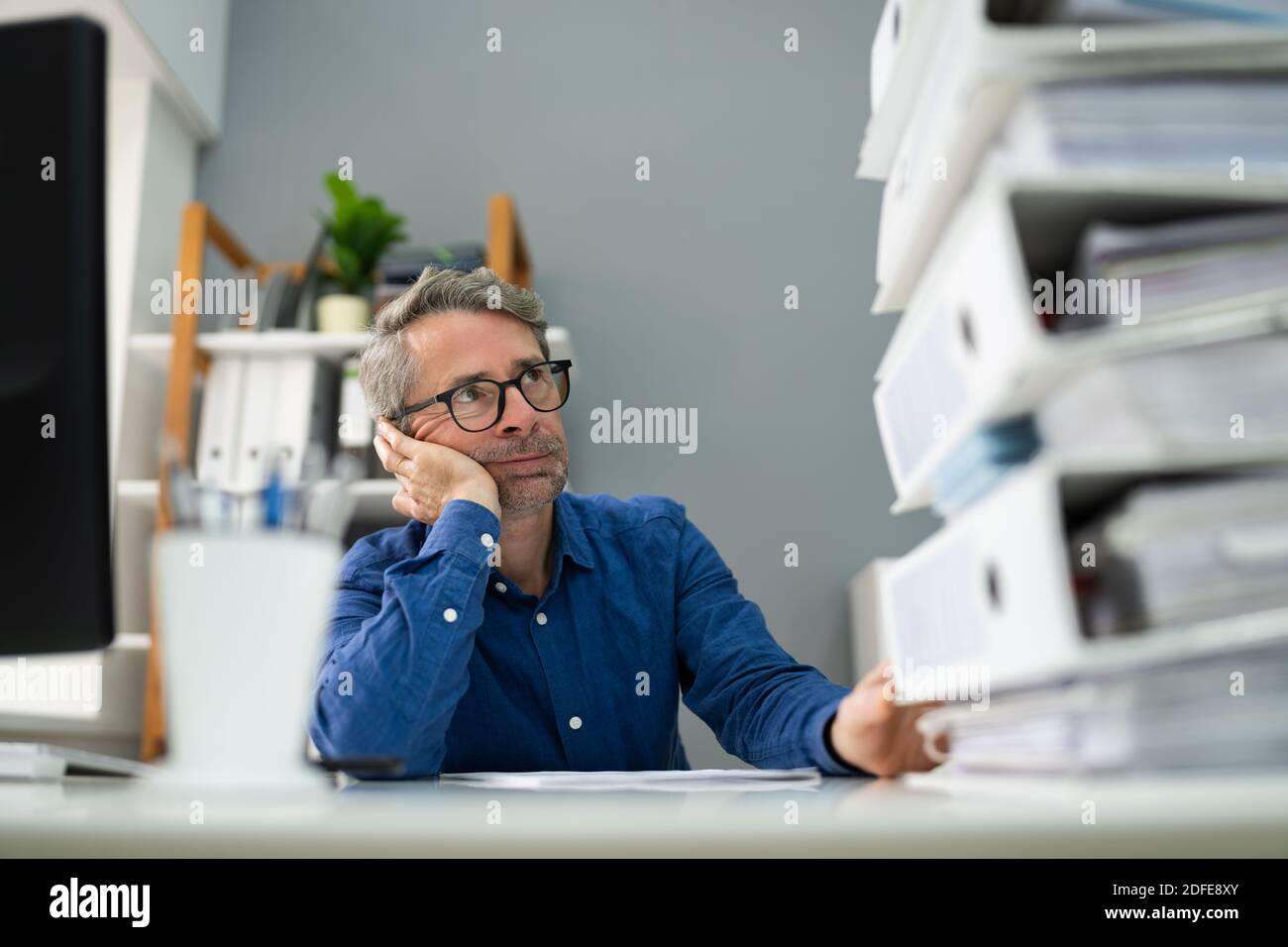 Sad Men With Office Paper Stack Workload And Pressure Stock Photo - Alamy