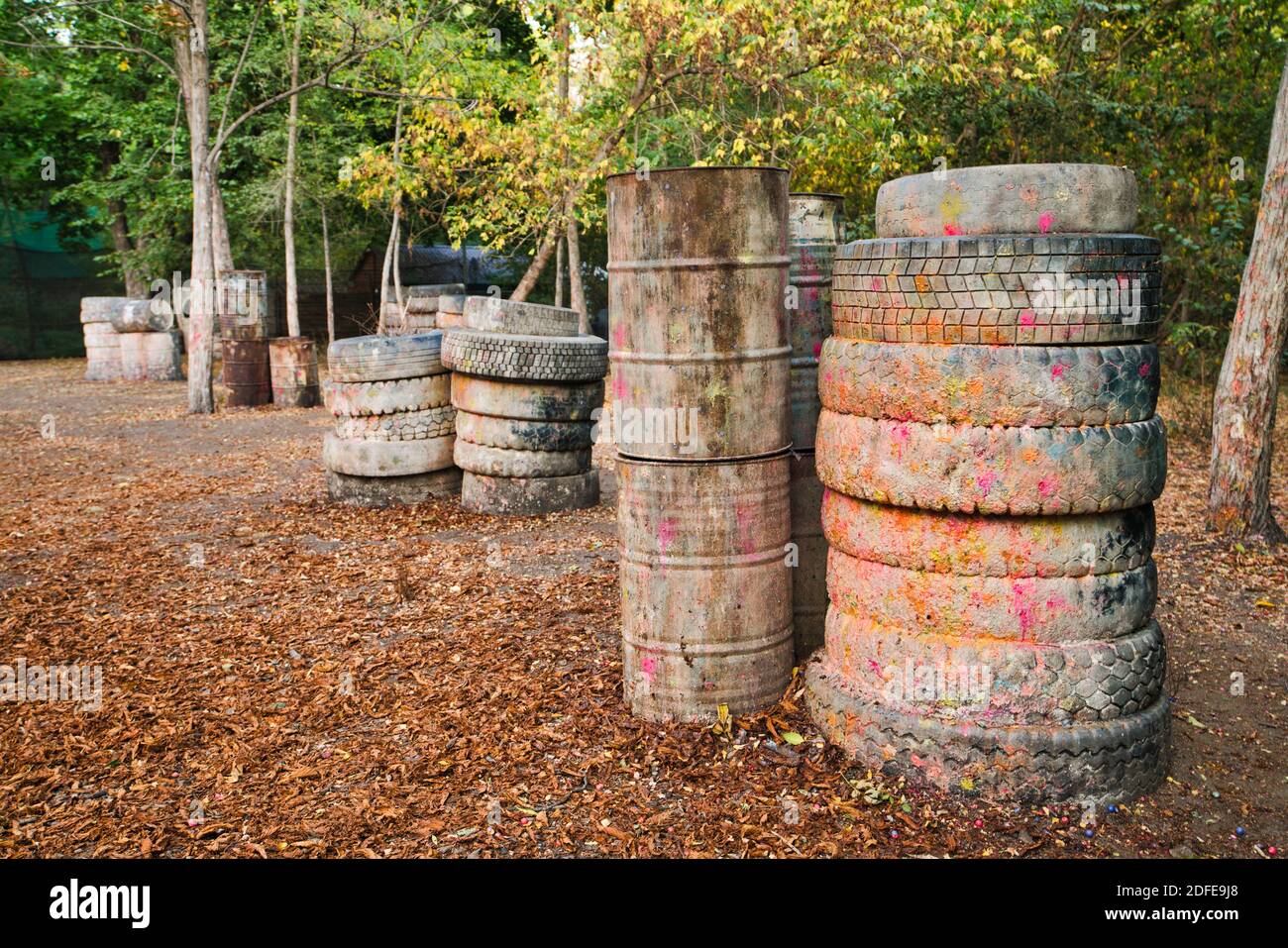 Old rusty barrels and damaged tires at the paintball base where the ...