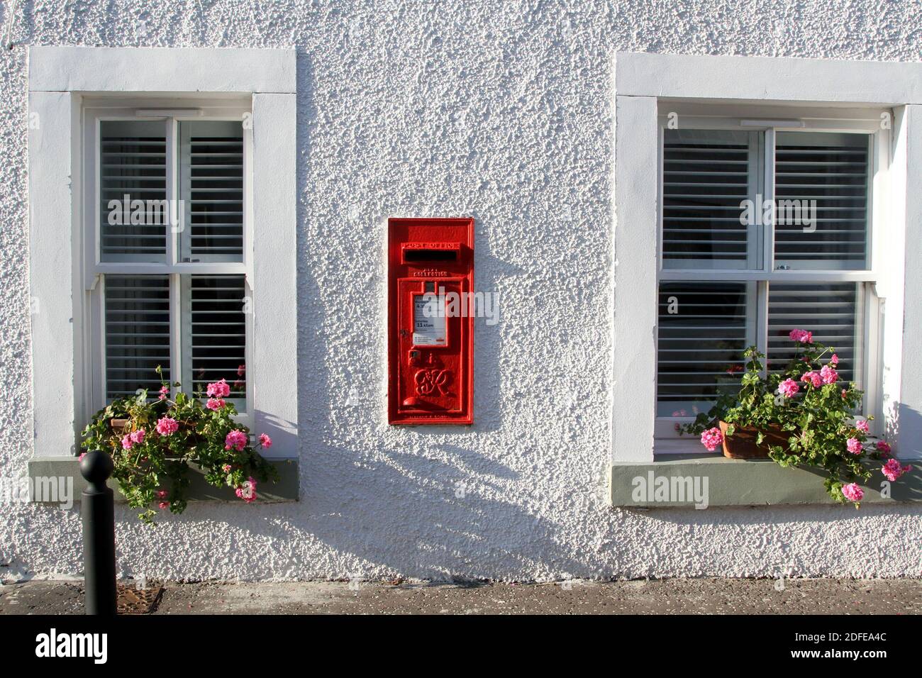 Abstract red pillar box white walls. The Red box contrasts with the two ...