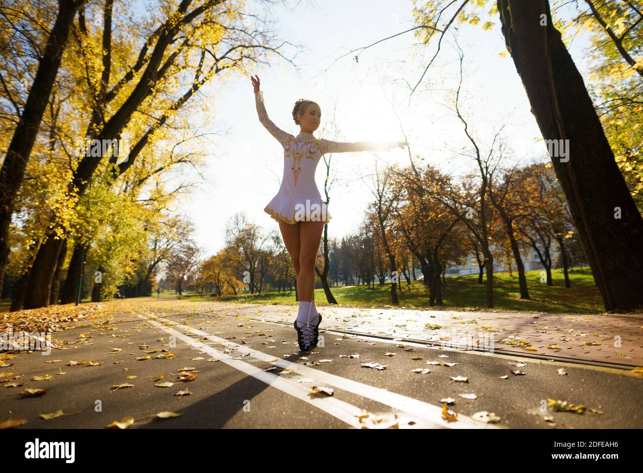 Ballerina dancing in nature park among autumn leaves Stock Photo - Alamy