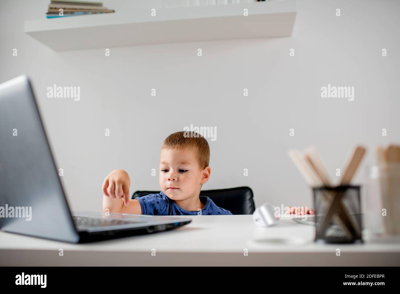 Little boy working on laptop at pediatrics mothers office Stock Photo ...
