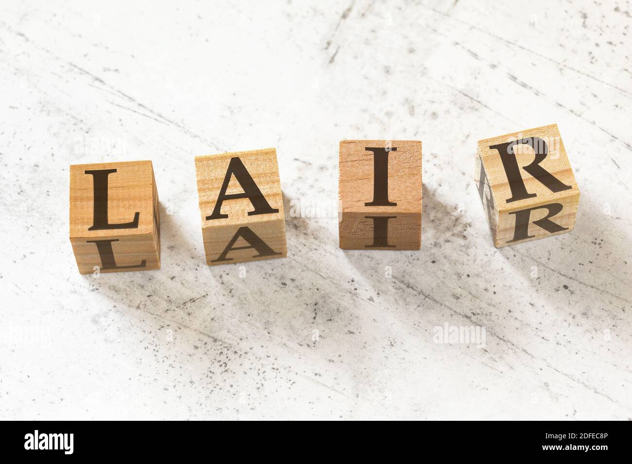 Four wooden cubes with letters LAIR (meaning Listen Acknowledge ...