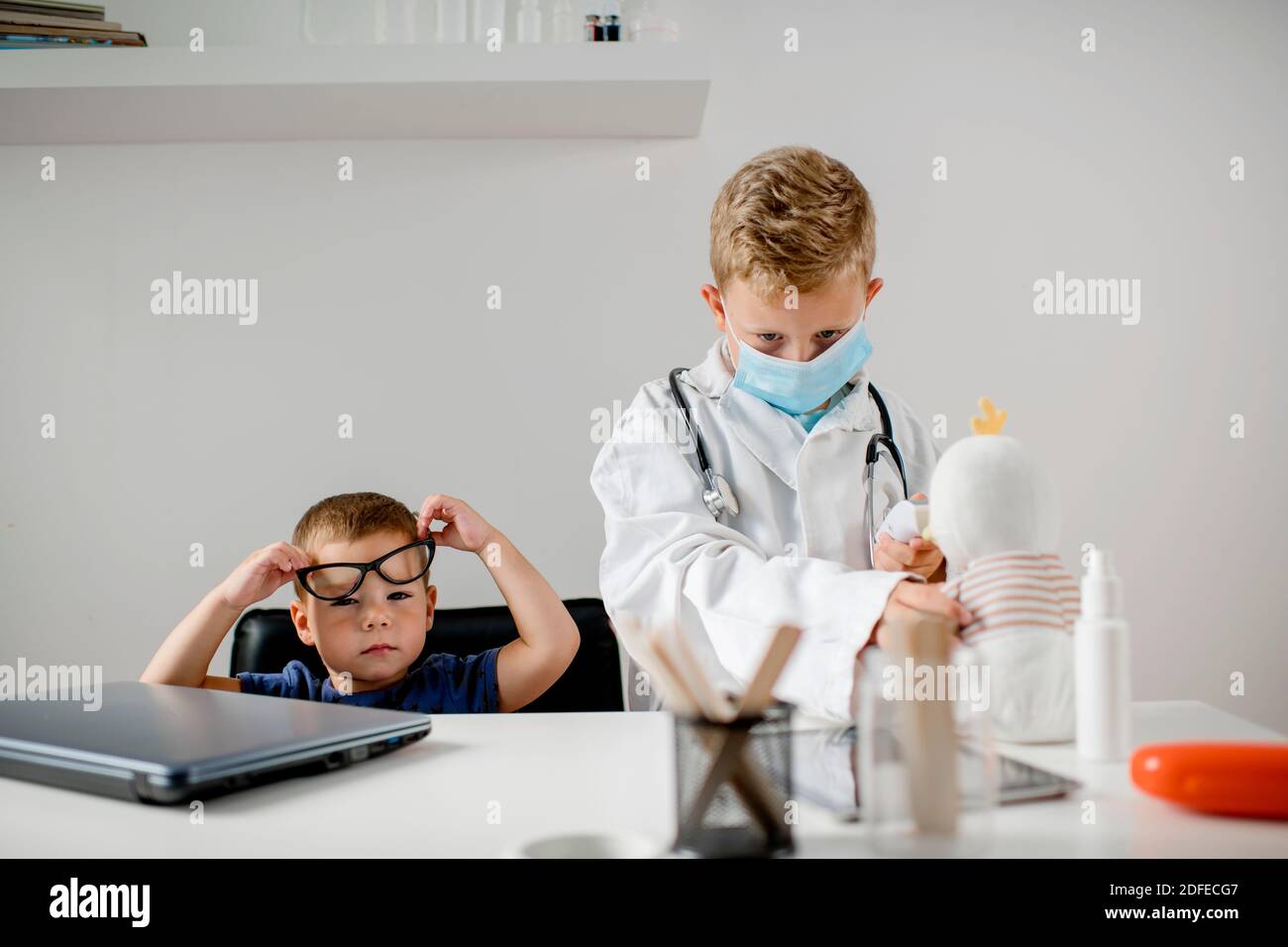 Two boys are playing doctors at parents office Stock Photo - Alamy