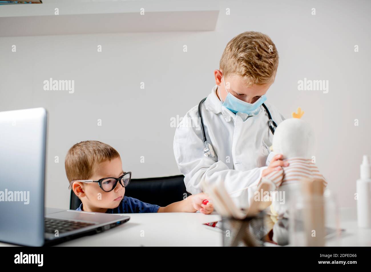 Two boys are playing doctors at parents office Stock Photo - Alamy