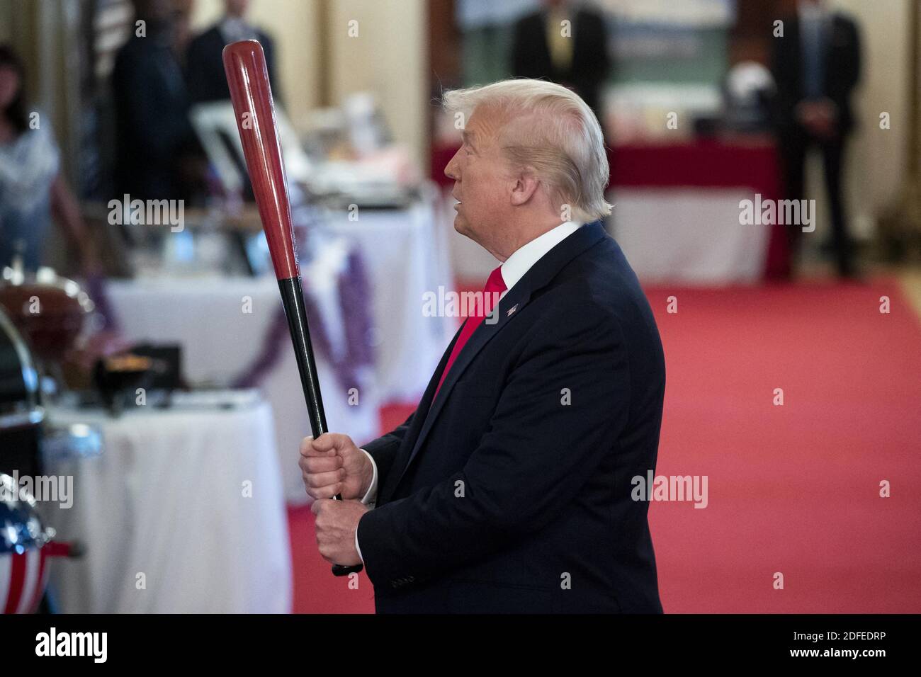 US President Donald J. Trump holds a baseball bat while participating ...