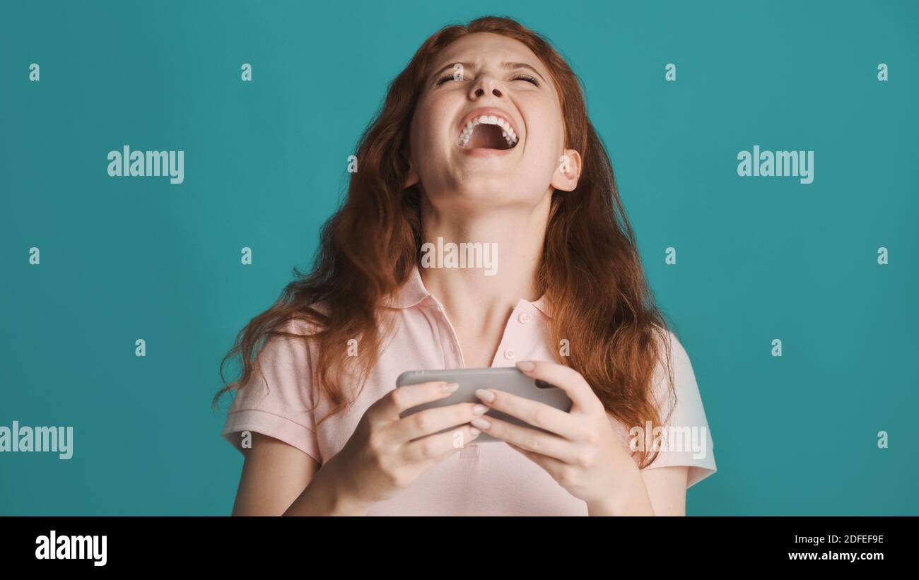 Pretty excited girl screaming while emotionally playing in game on ...