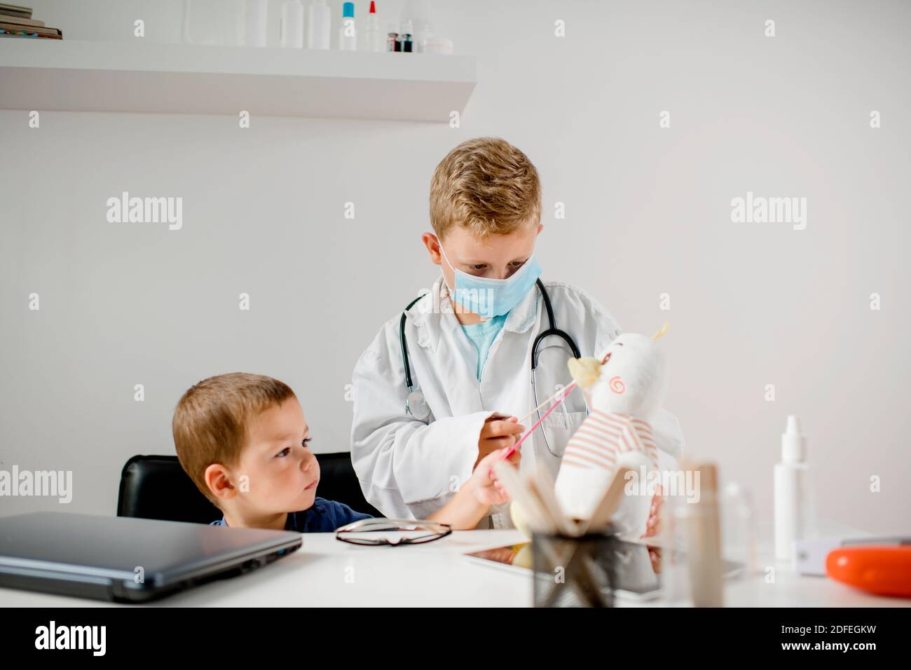 Two boys are playing doctors at parents office Stock Photo - Alamy