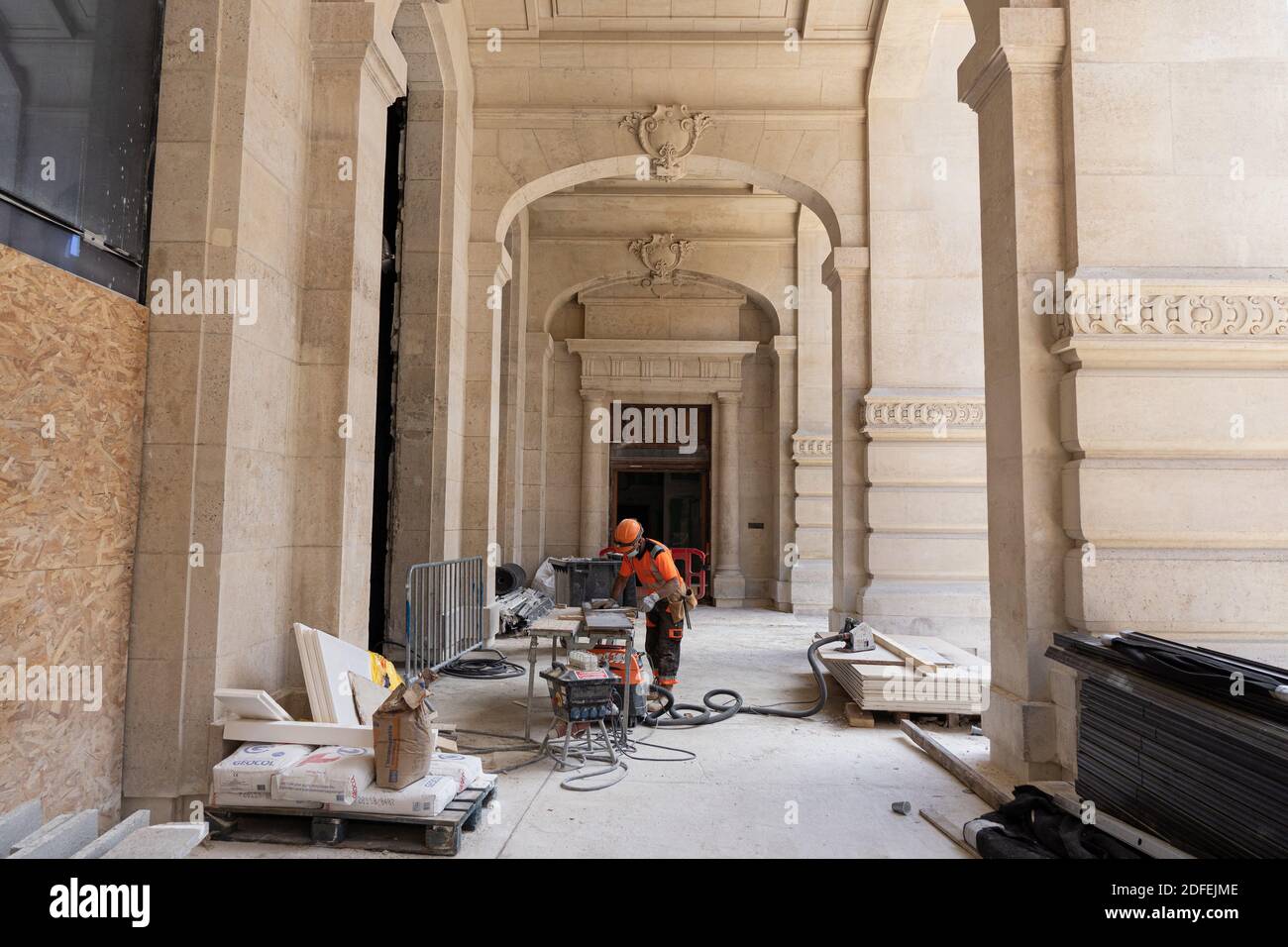 A worker at the Poste du Louvre building that is under renovation ...