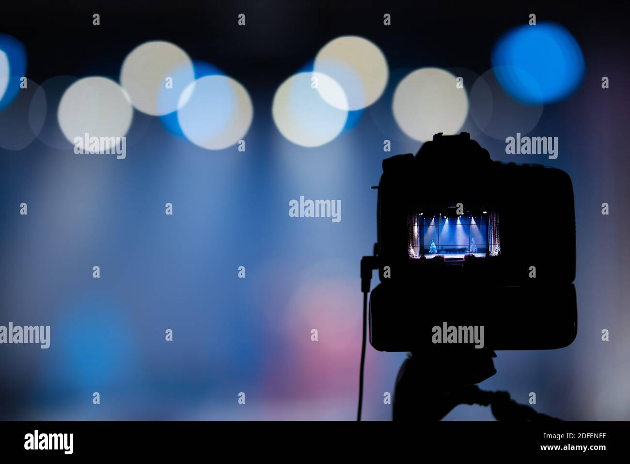 Photo camera shoots a concert program in the theater hall. Blur texture ...