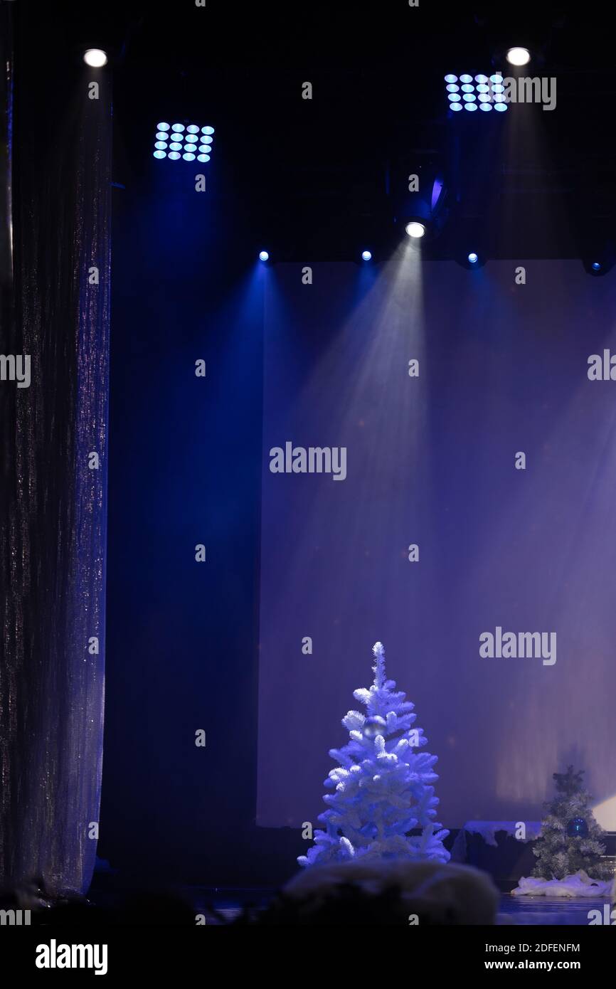 scene, stage light with colored spotlights and smoke, christmas tree ...