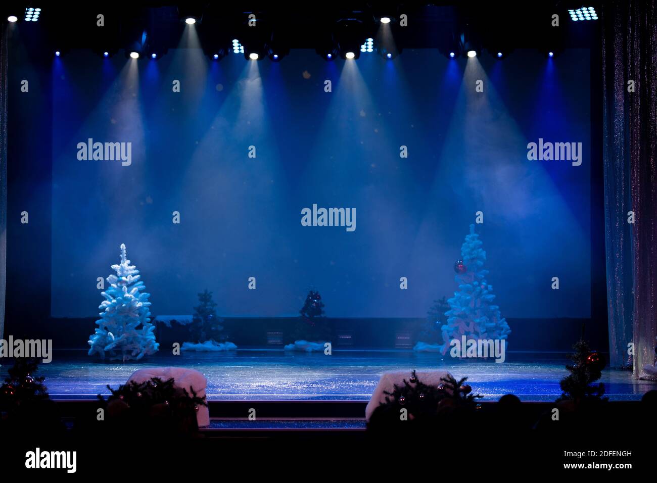 scene, stage light with colored spotlights and smoke, christmas tree ...
