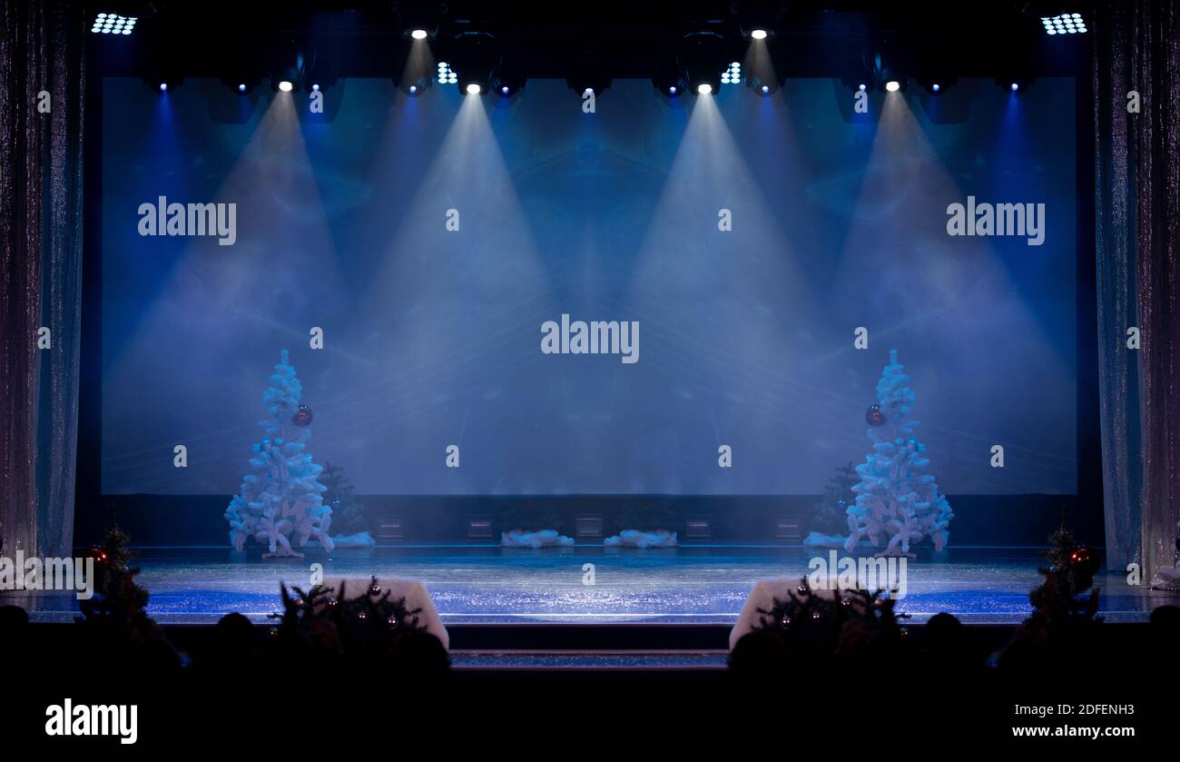 scene, stage light with colored spotlights and smoke, christmas tree ...