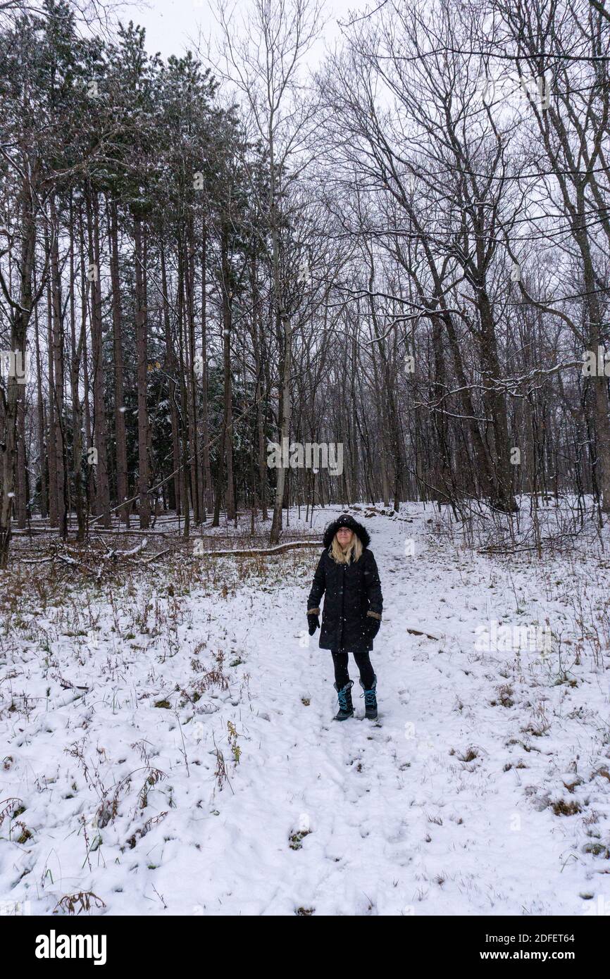 Woman standing among trees hi-res stock photography and images - Alamy