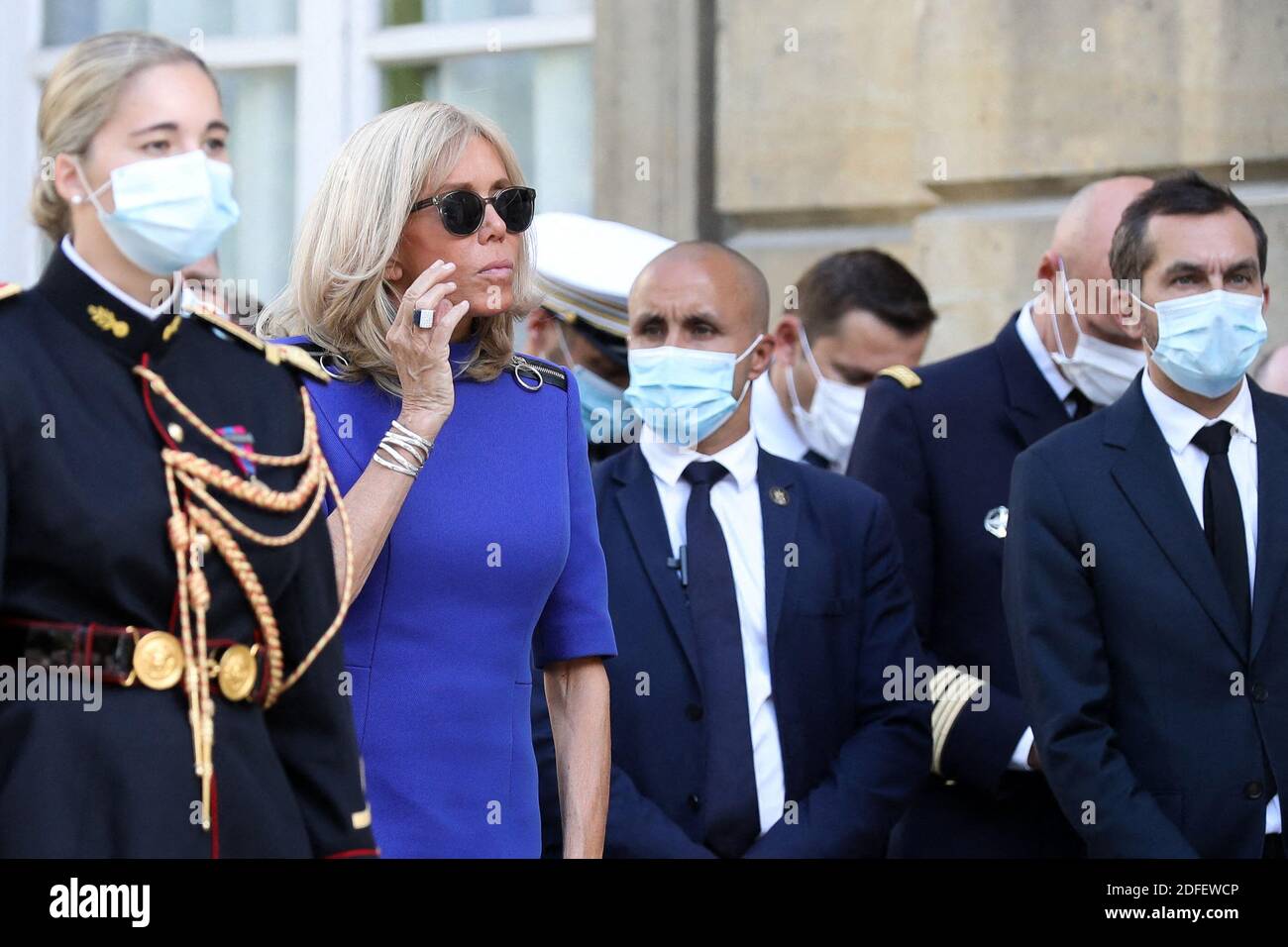 French President Emmanuel Macron accompanied by the first lady ...