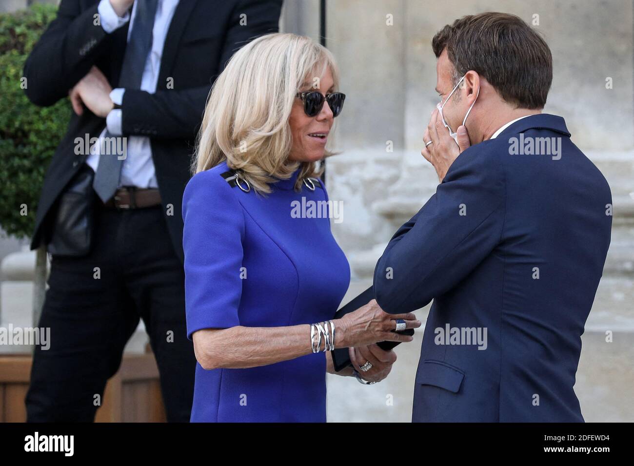 French President Emmanuel Macron accompanied by the first lady ...