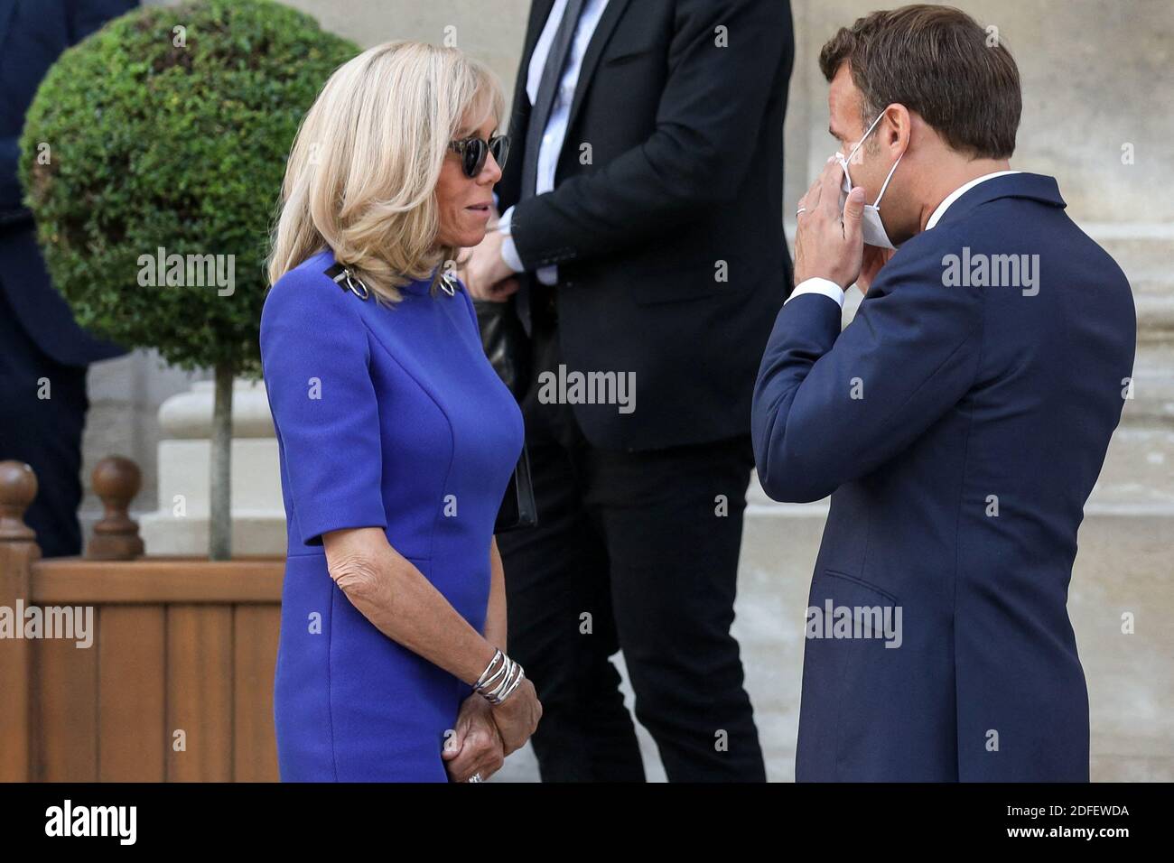 French President Emmanuel Macron accompanied by the first lady ...