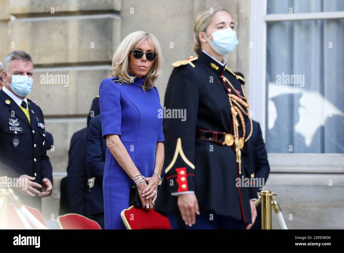 French President Emmanuel Macron accompanied by the first lady ...
