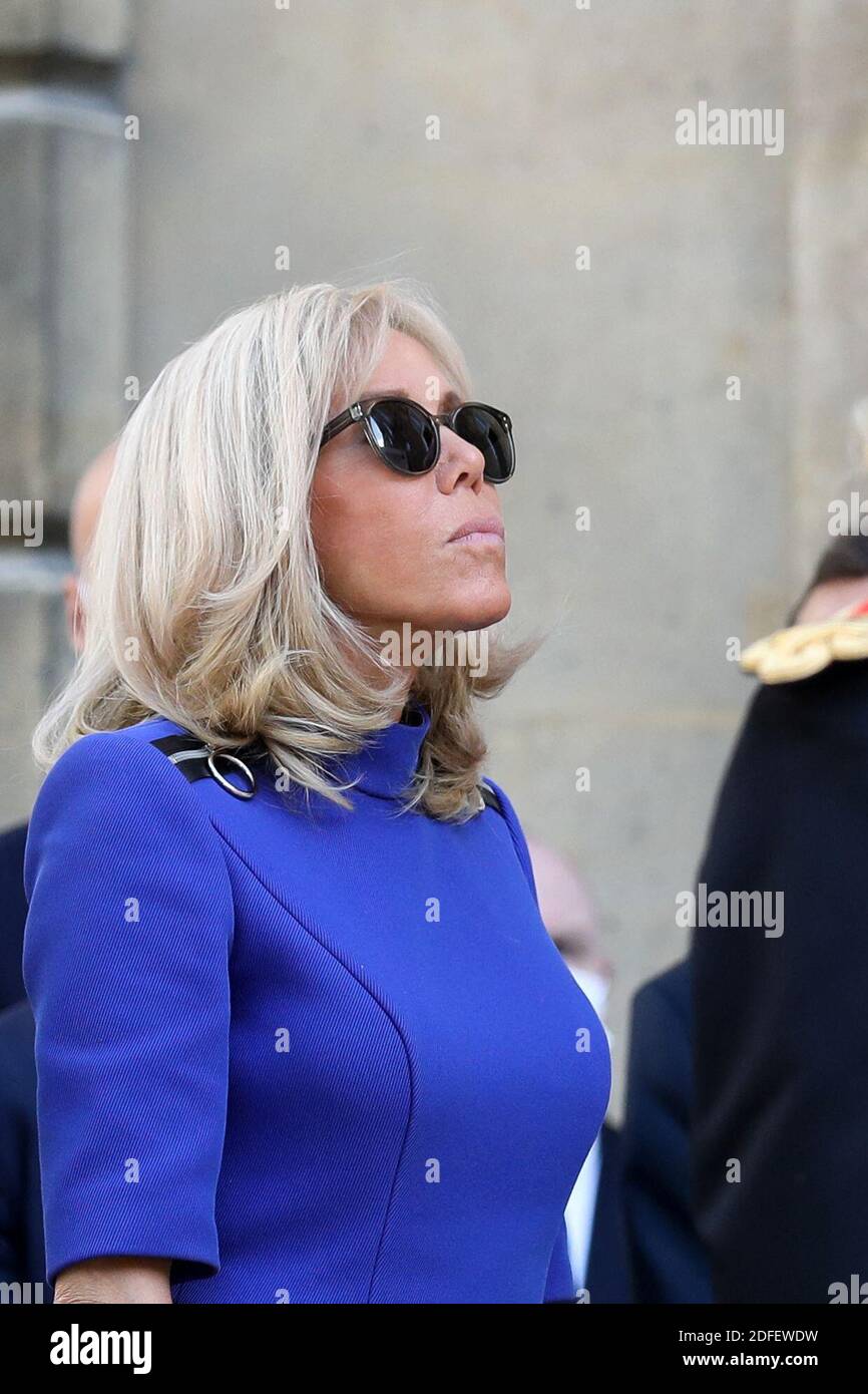 French President Emmanuel Macron accompanied by the first lady ...
