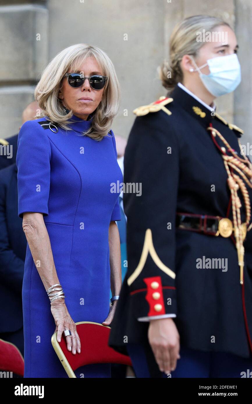 French President Emmanuel Macron accompanied by the first lady ...