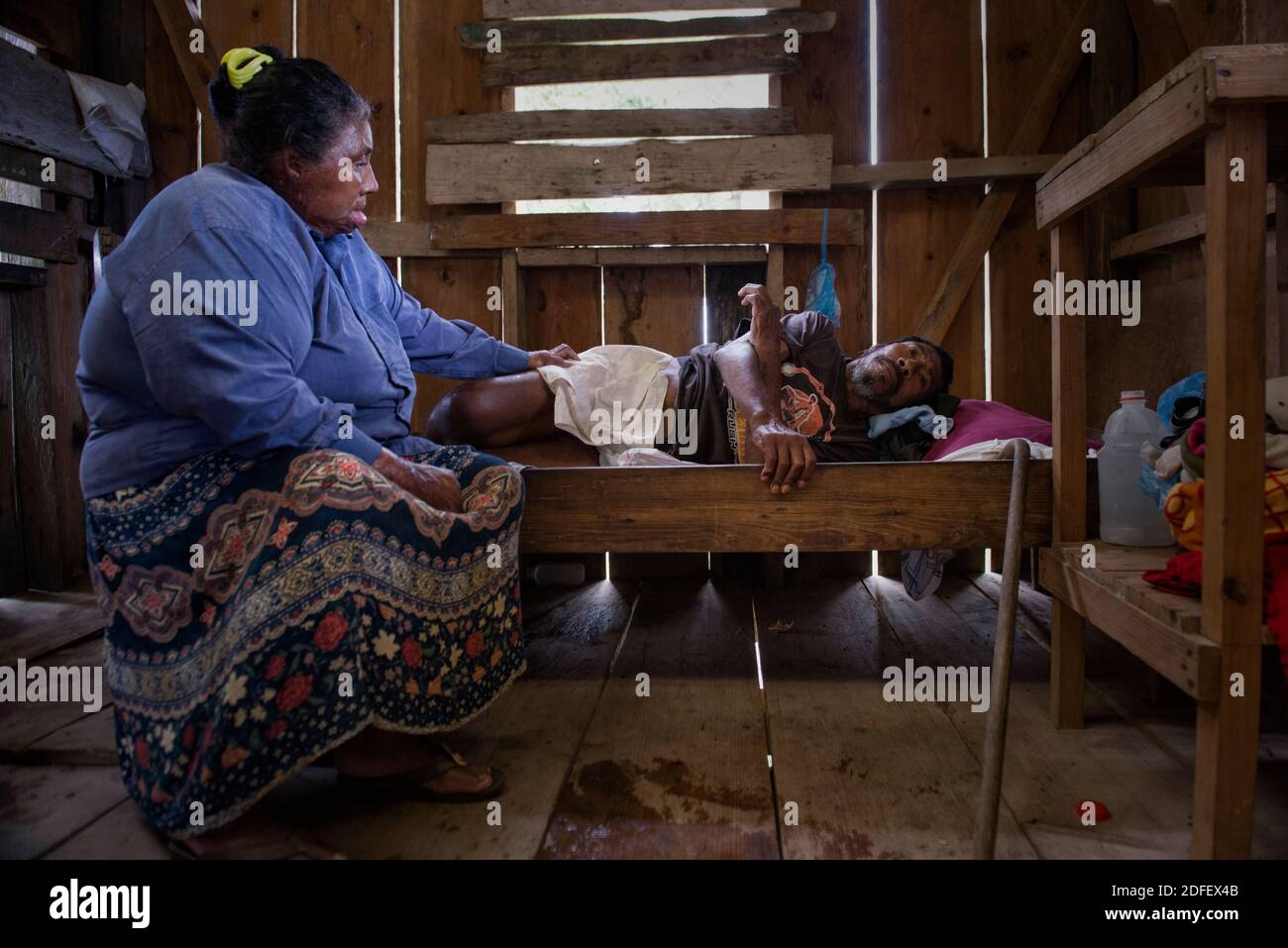 Woman taking care of a disabled person with severe bedsores paralyzed ...