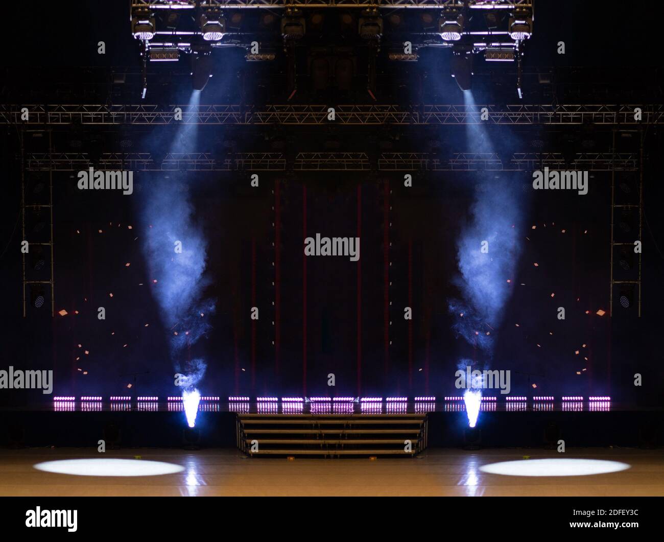 An empty stage of the theater, lit by spotlights and smoke before the ...