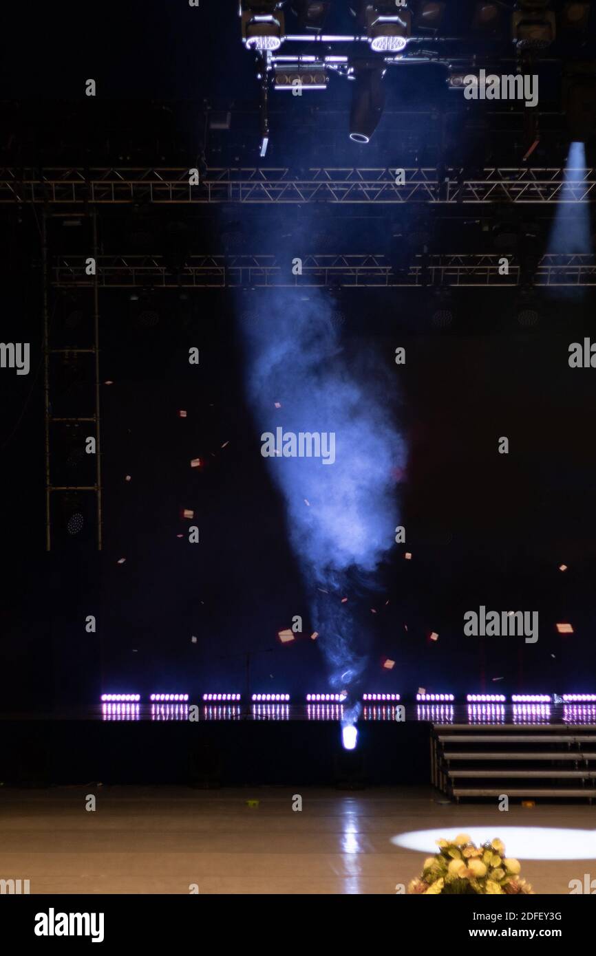 An empty stage of the theater, lit by spotlights and smoke before the ...