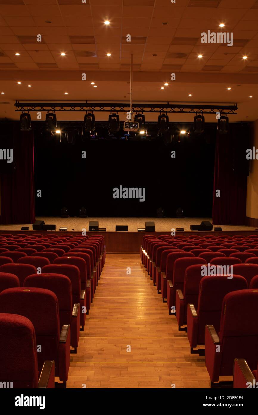 An empty stage of the theater, lit by spotlights and smoke before the ...