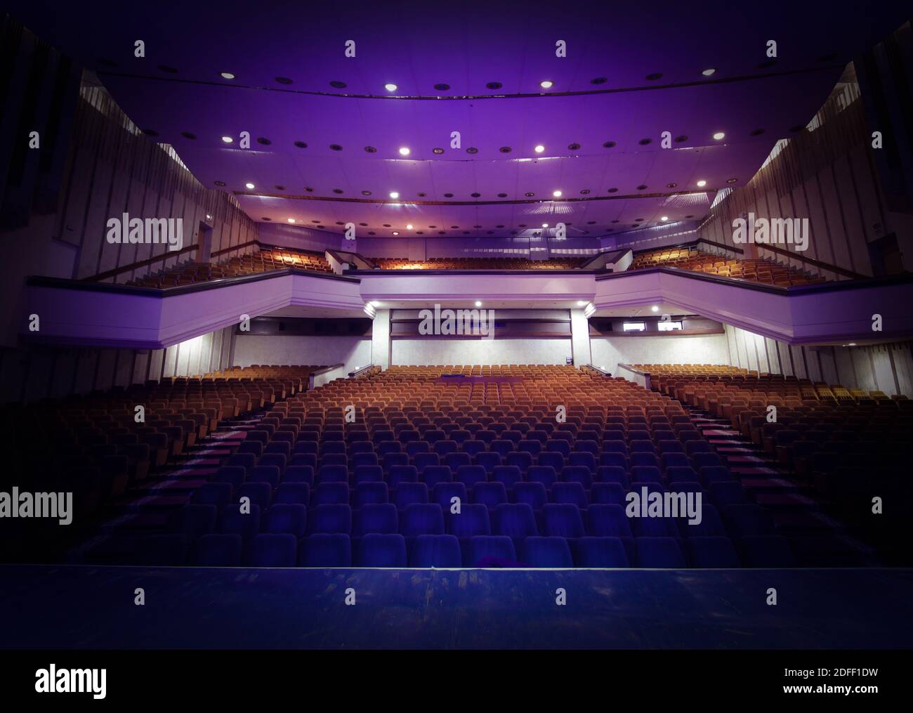 Interior of a concert hall or theater with light and velvet chairs ...