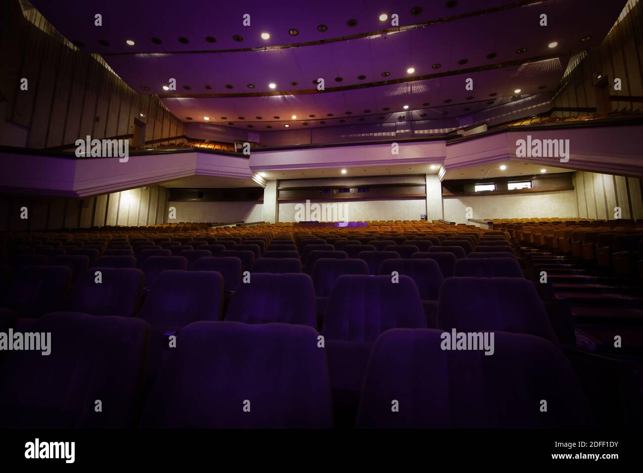 Interior of a concert hall or theater with light and velvet chairs ...