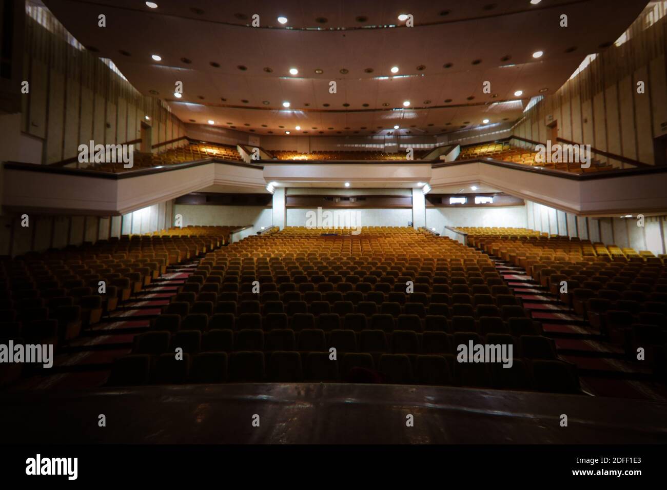 Interior of a concert hall or theater with light and velvet chairs ...