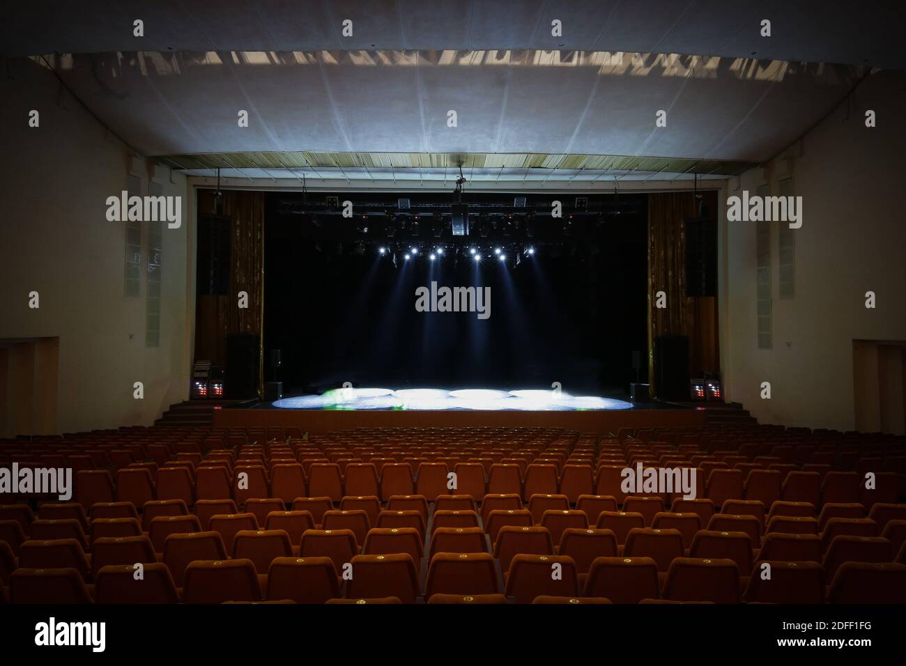 An empty stage of the theater, lit by spotlights and smoke before the ...