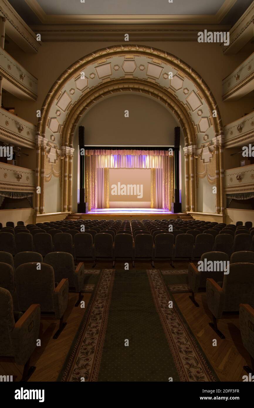 An empty stage of the theater, lit by spotlights and smoke before the ...