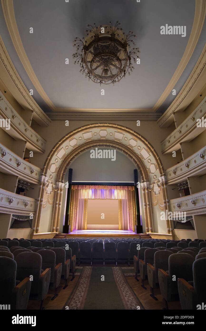 An empty stage of the theater, lit by spotlights and smoke before the ...