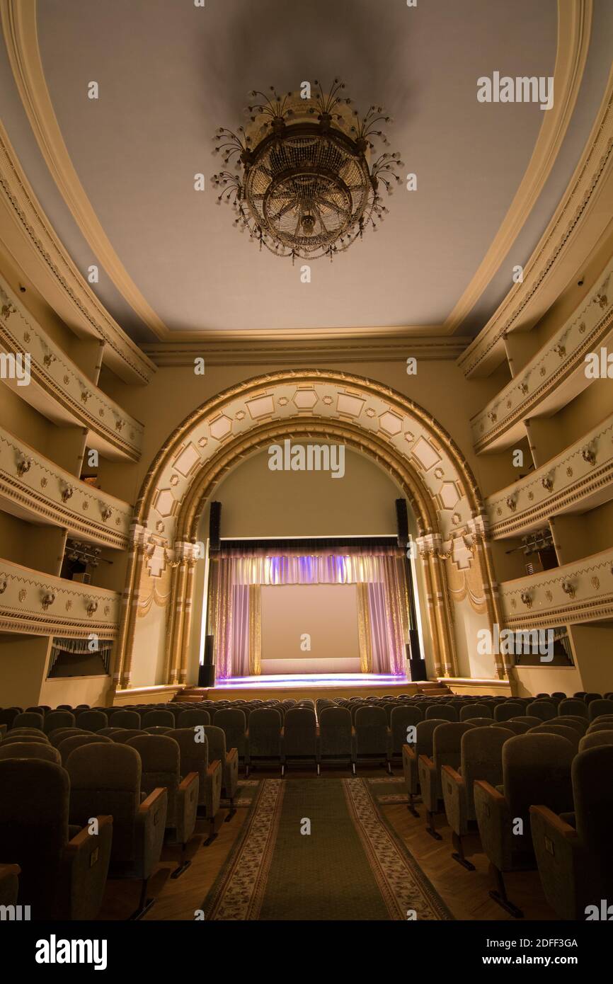 An empty stage of the theater, lit by spotlights and smoke before the ...