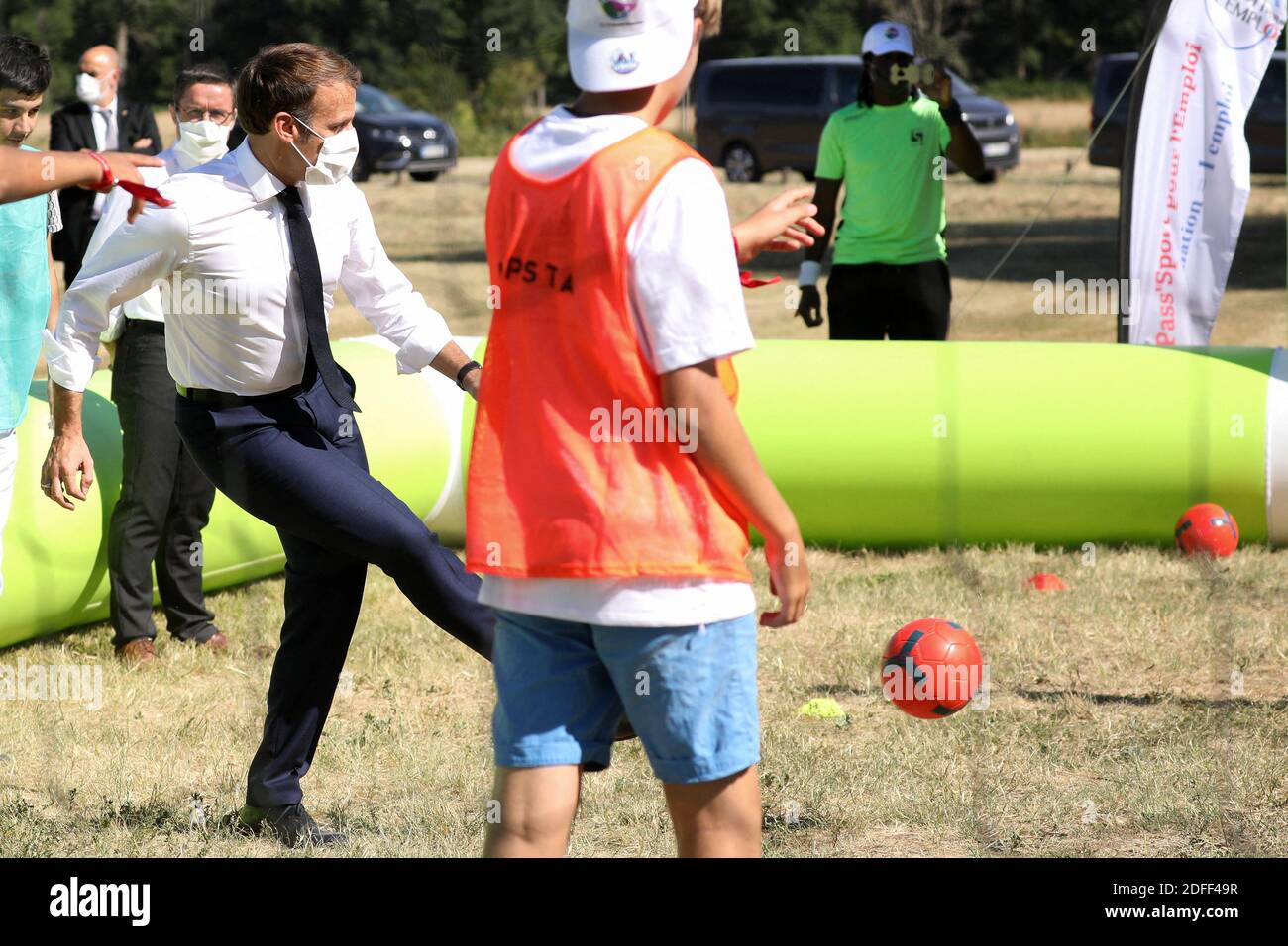 President Emmanuel Macron plays football with youth taking part in a ...