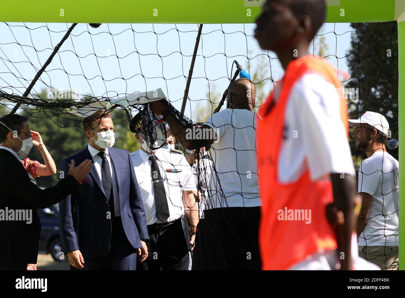 President Emmanuel Macron plays football with youth taking part in a ...