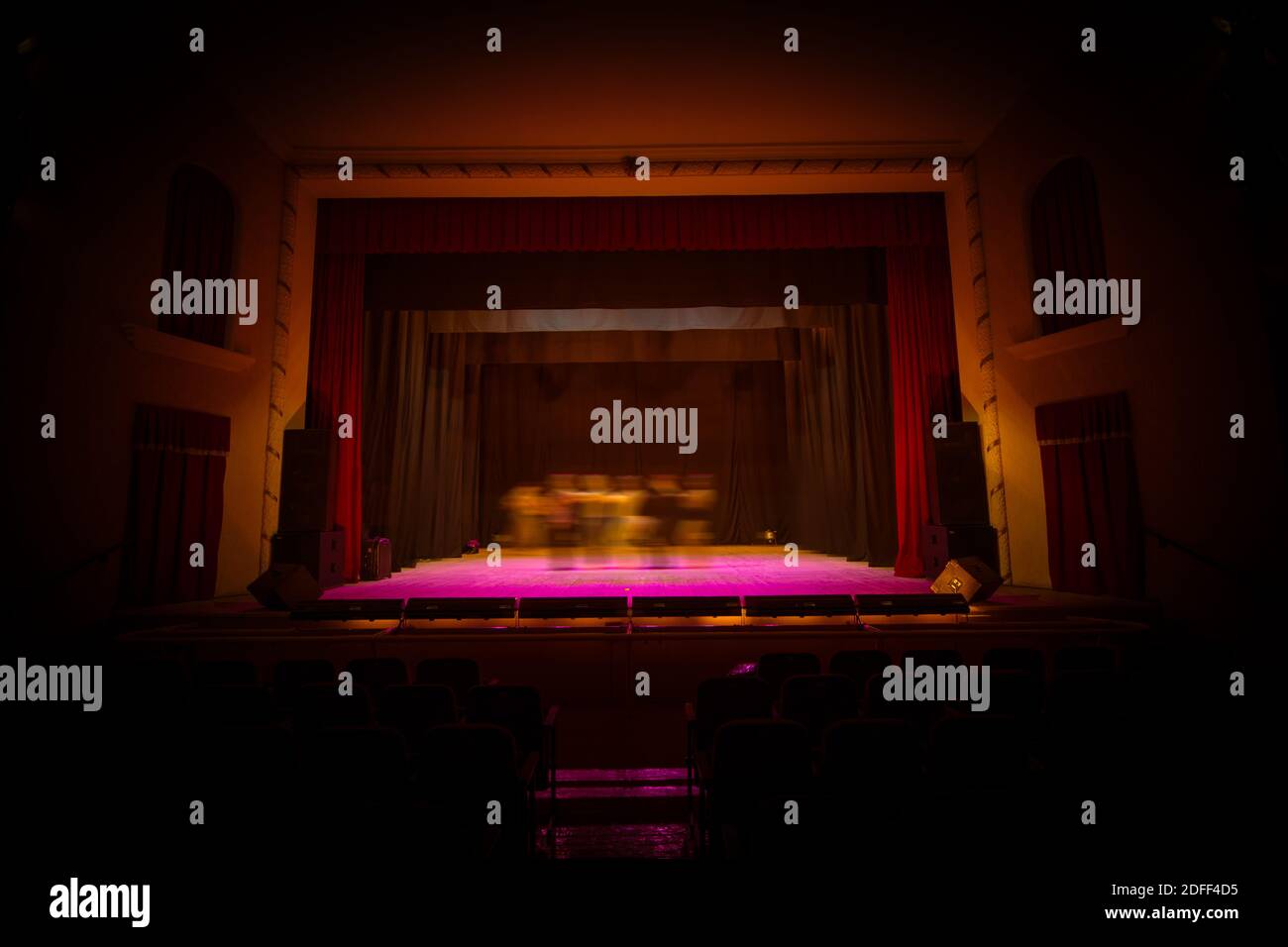 An empty stage of the theater, lit by spotlights and smoke before the ...