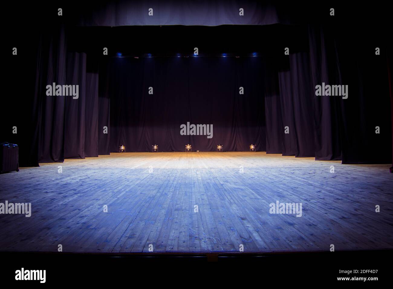 An empty stage of the theater, lit by spotlights before the performance ...