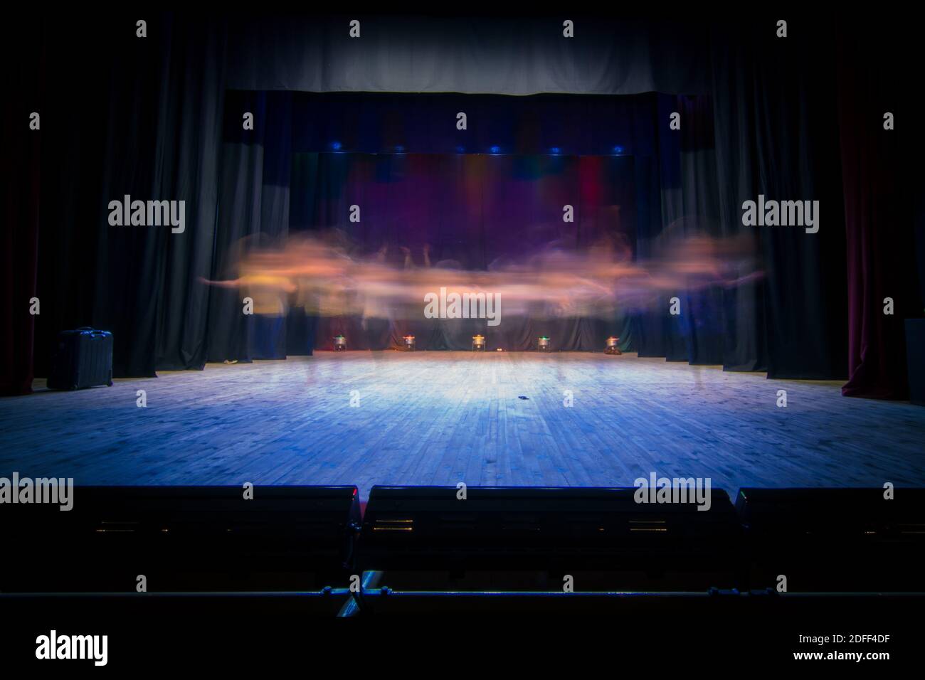 An empty stage of the theater, lit by spotlights and smoke before the ...