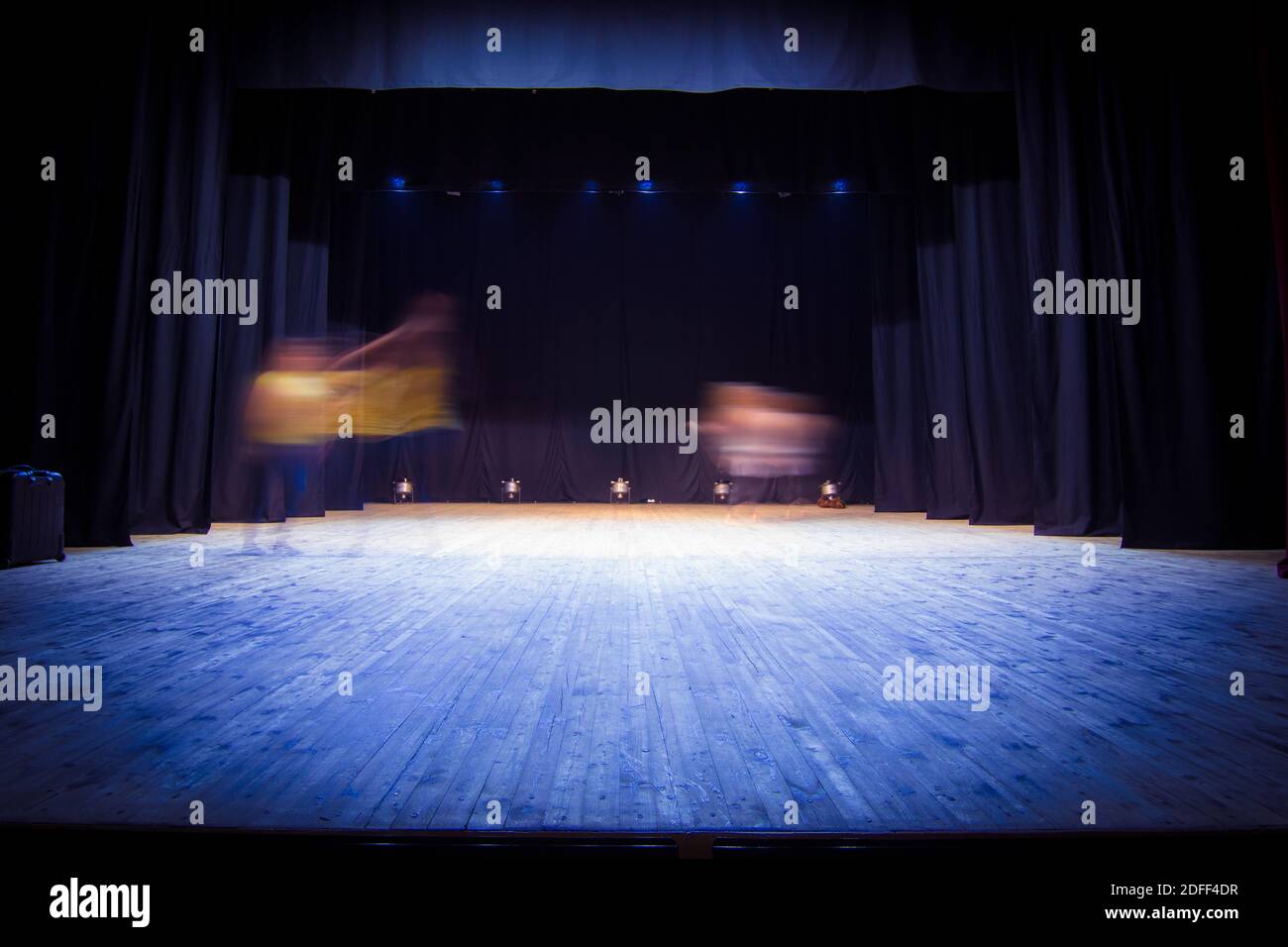 An empty stage of the theater, lit by spotlights before the performance ...