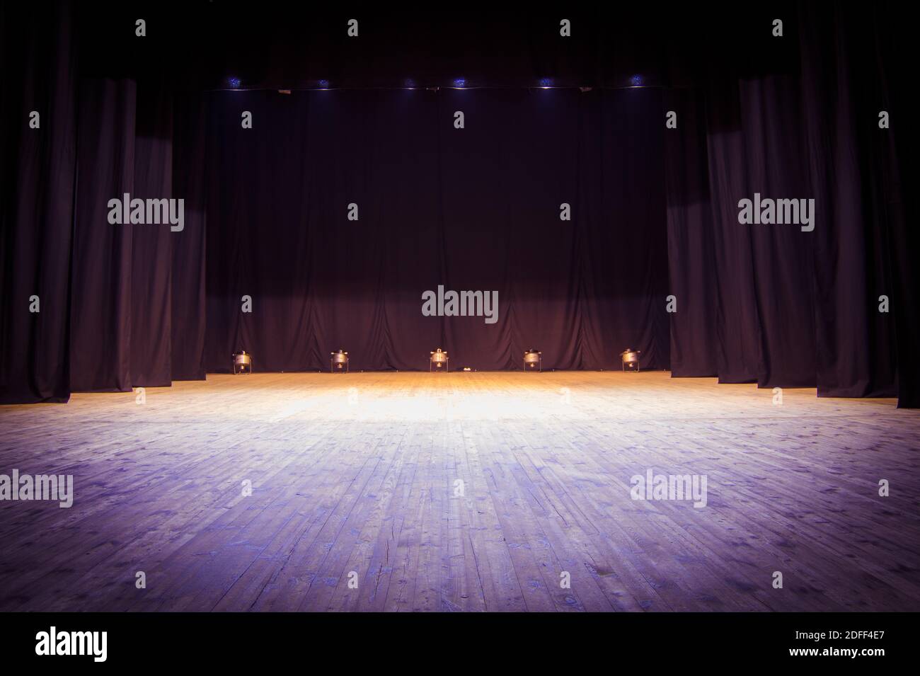 An empty stage of the theater, lit by spotlights before the performance ...
