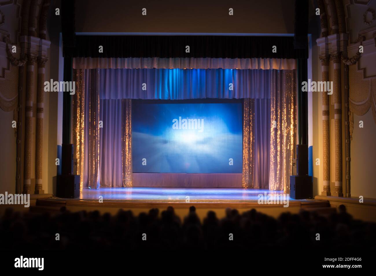 An empty stage of the theater, lit by spotlights and smoke before the ...