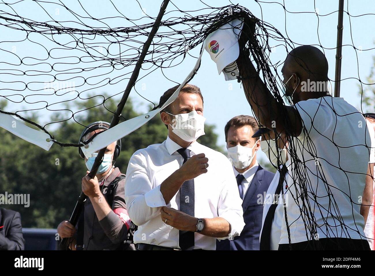 President Emmanuel Macron plays football with youth taking part in a ...