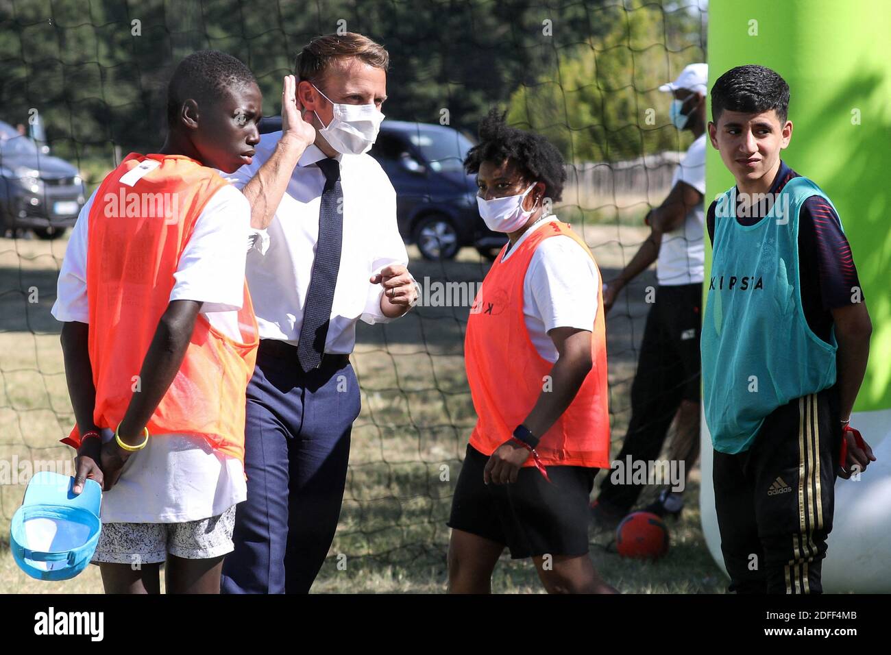 President Emmanuel Macron plays football with youth taking part in a ...