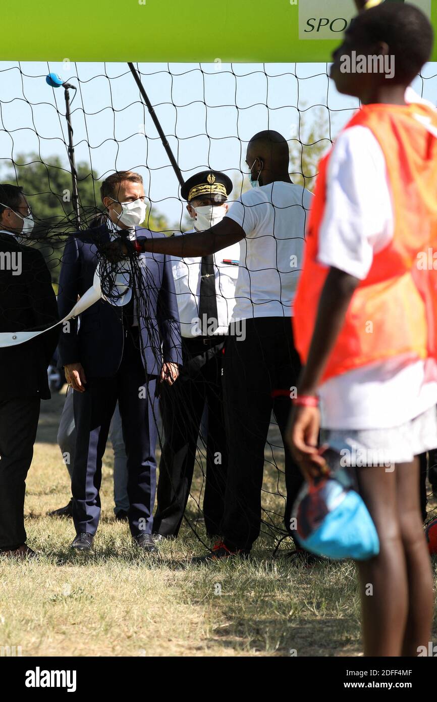 President Emmanuel Macron plays football with youth taking part in a ...