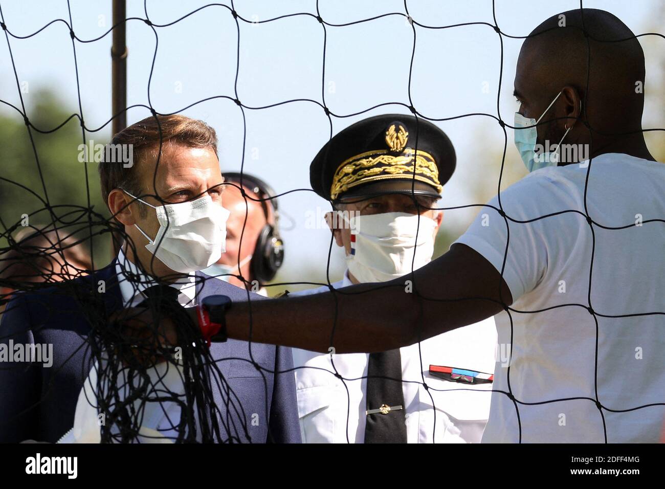 President Emmanuel Macron plays football with youth taking part in a ...